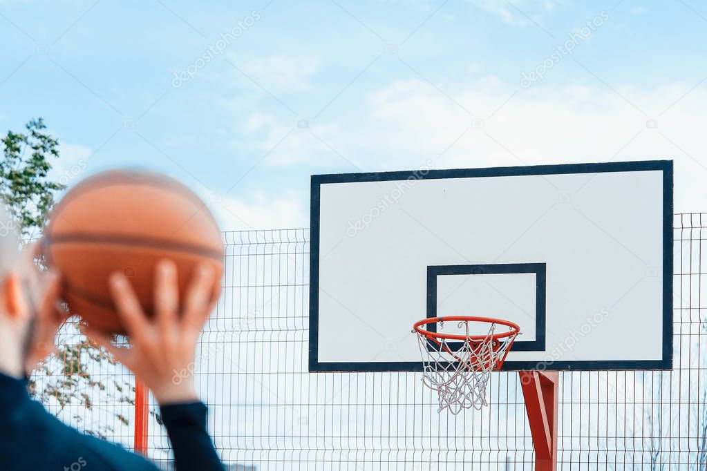 Hombre atractivo jugando al baloncesto y metiendo baloncesto en el aro ...