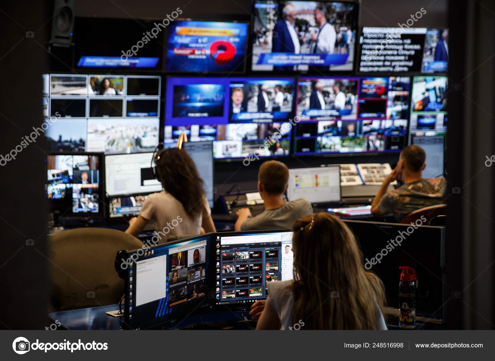 Television operator working on the computer. Big broadcast center at ...