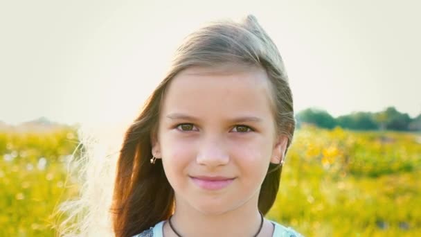 Portrait of attractive little girl with a big green eyes on nature background with developing ...