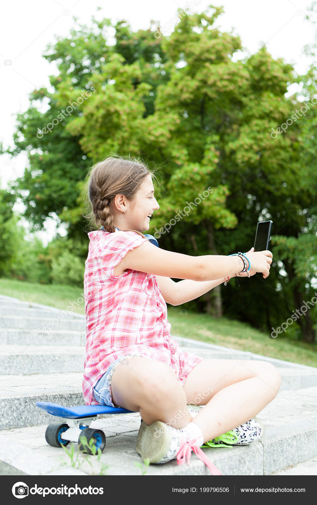 Girl taking photos in the park — Stock Photo © DragosCondreaW #199796506