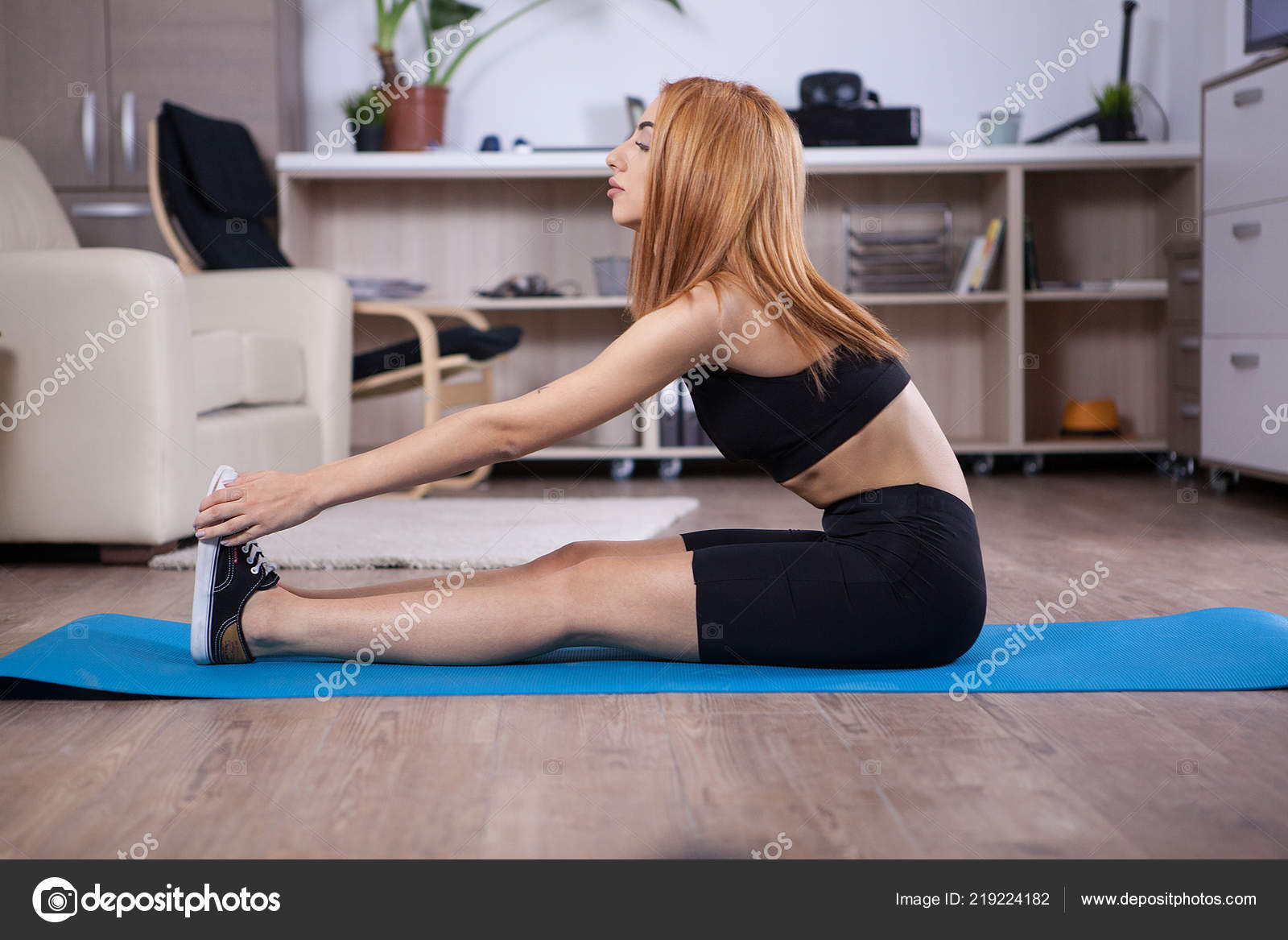 Blonde girl stretching her hamstring during her yoga time. Stock Photo ...