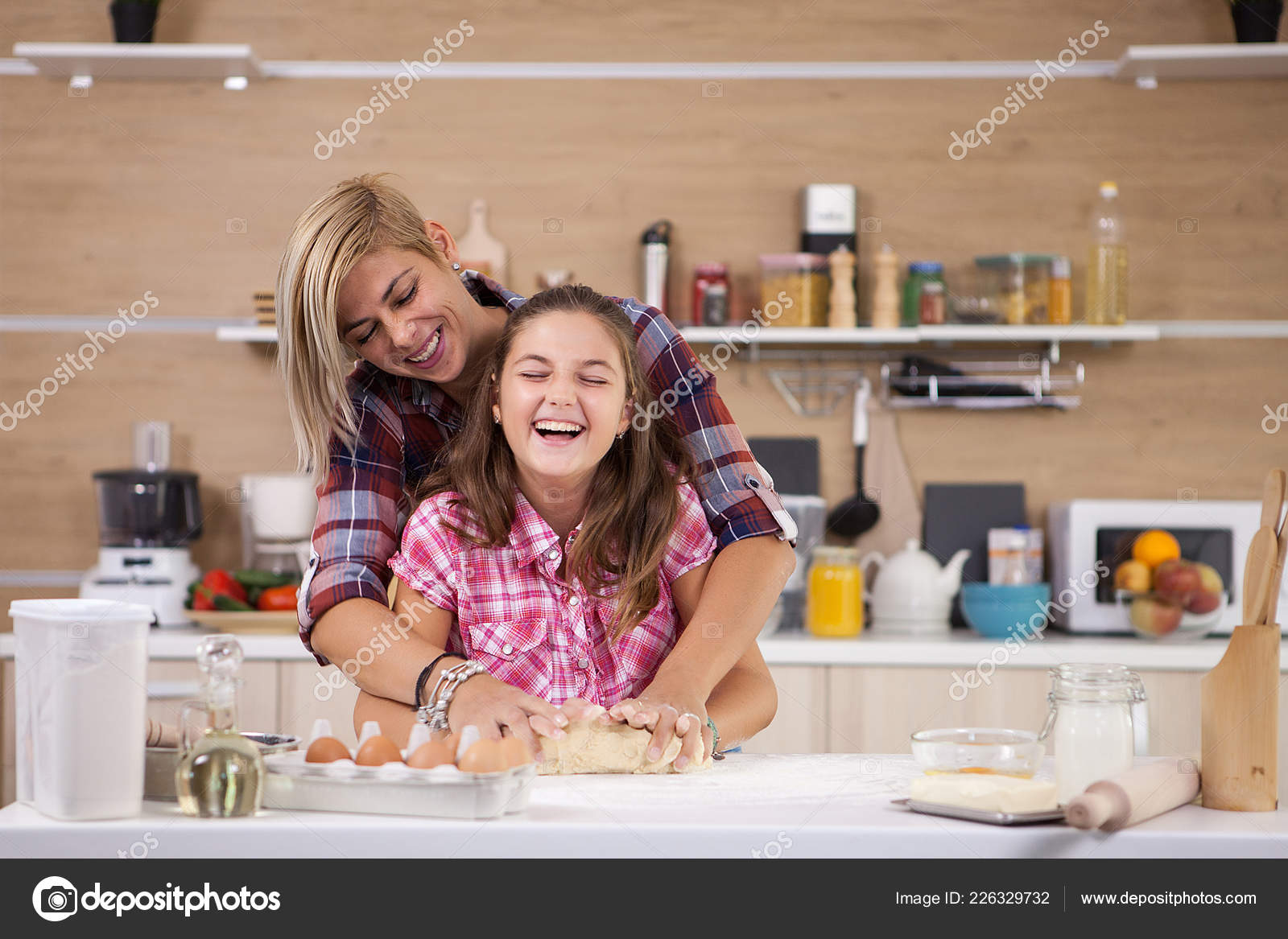 Portrait of excited mom and daughter having fun while cooking Stock ...