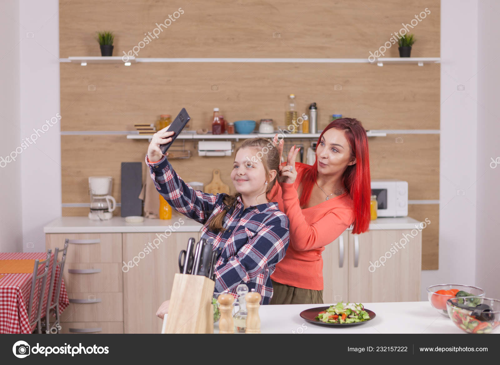 Mother and daughter cooking and taking selfies Stock Photo by ...