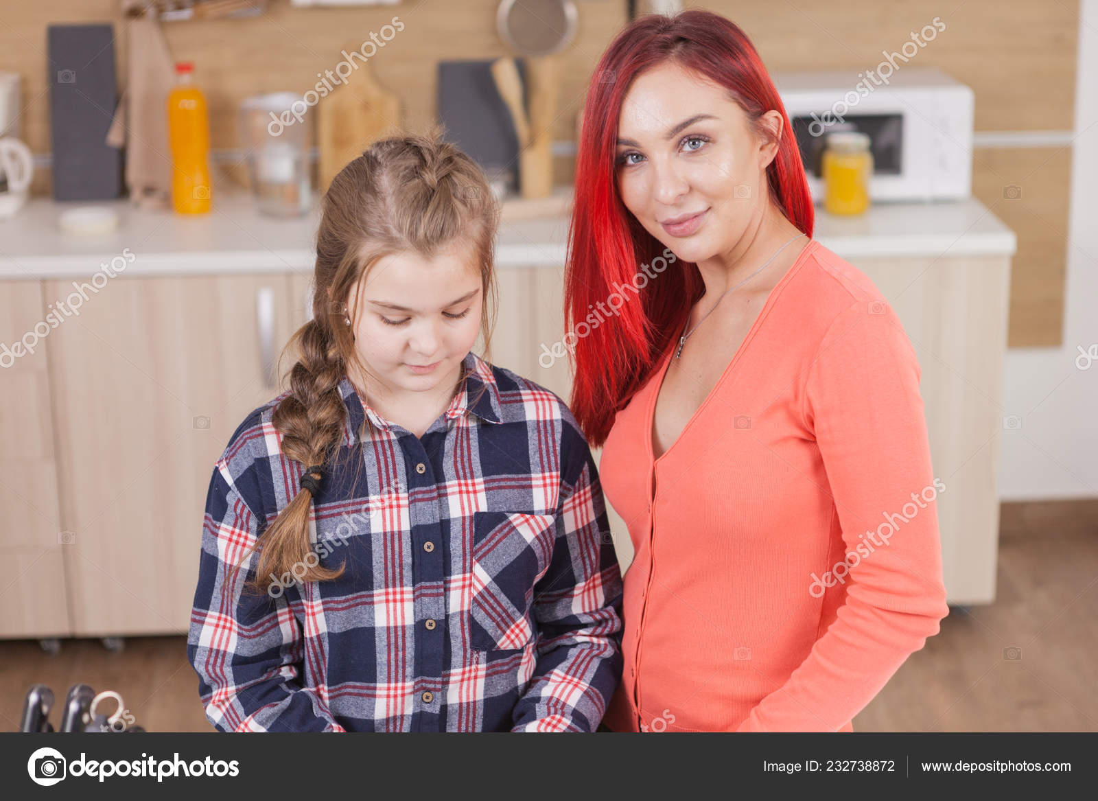Beautiful mother and daughter cooking together Stock Photo by ...