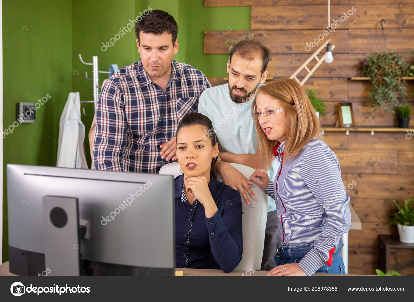 Young colleagues having a conversation with their female manager ...