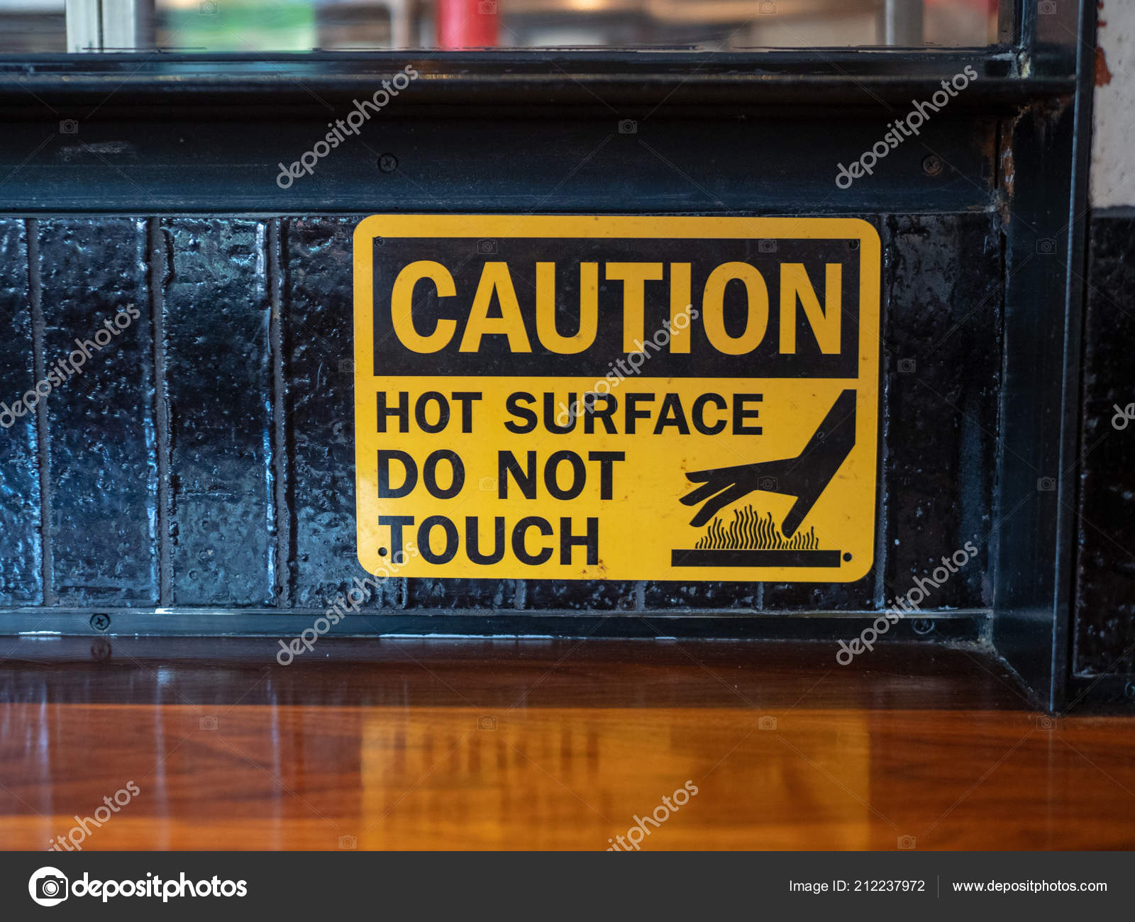Caution hot surface, do not touch sign in front of a grill at a ...