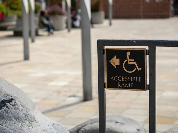 Gold and black accessible entry sign posting with wheelchair handicap ...