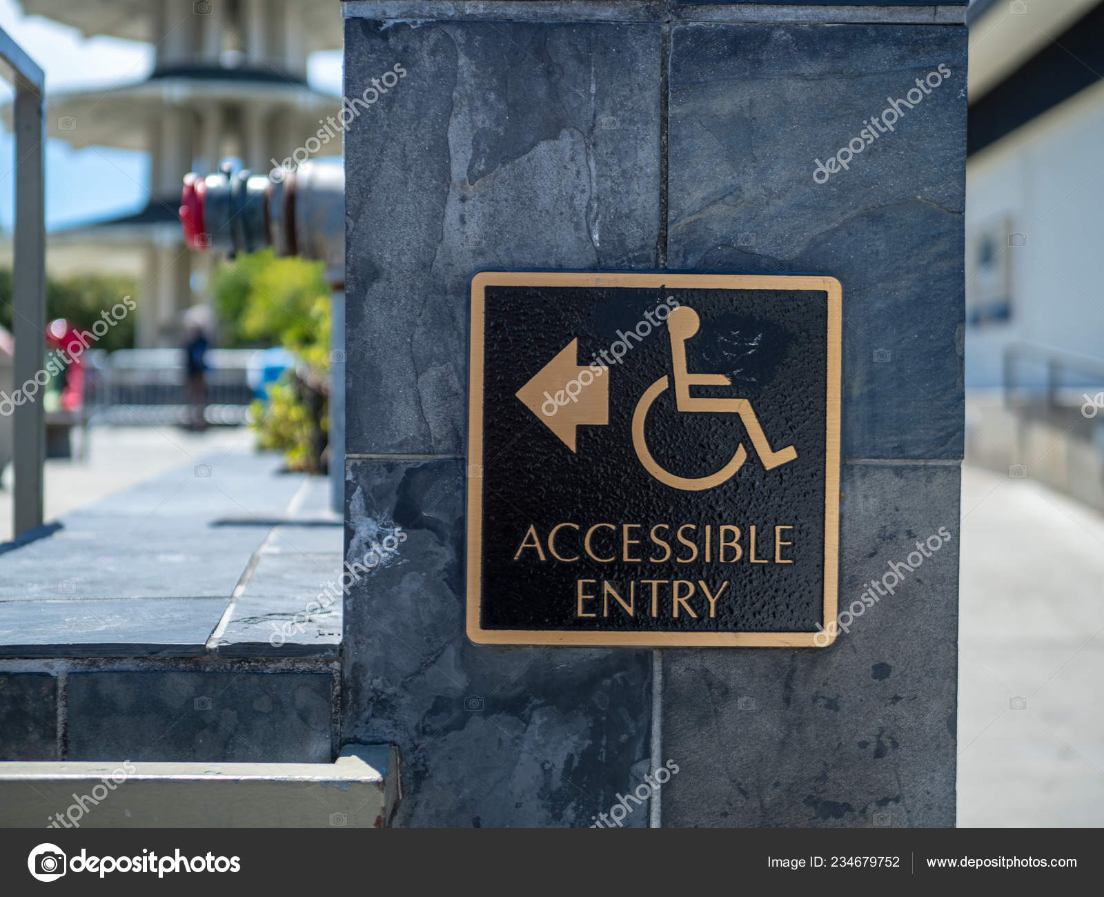 Gold and black accessible entry sign posting with wheelchair handicap ...