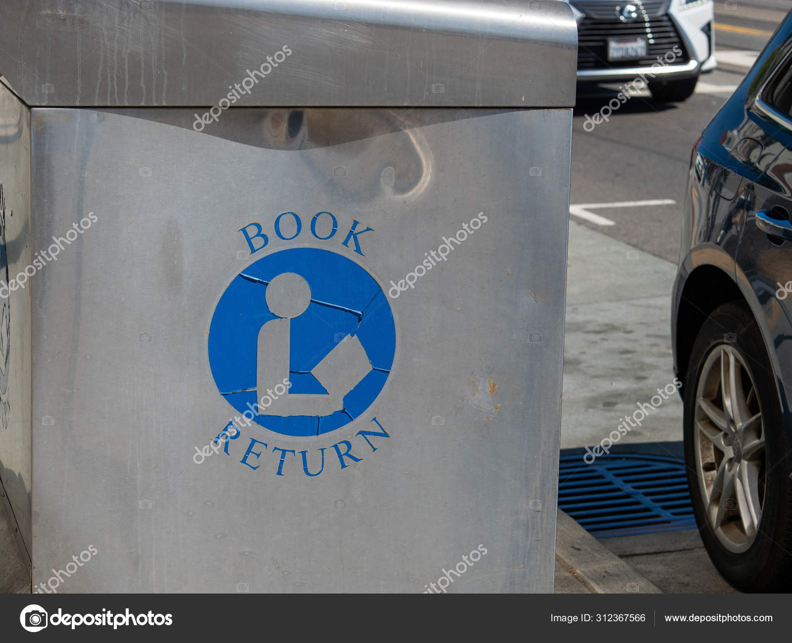 Book return symbol and label on outdoor book drop on street at library ...