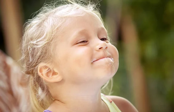 Cute little girl child with traces of ice cream on her face on a Stock ... Cute little girl child with traces of ice cream on her face on a Stock ...