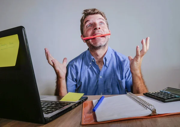 young crazy stressed and overwhelmed man working messy at office desk ...