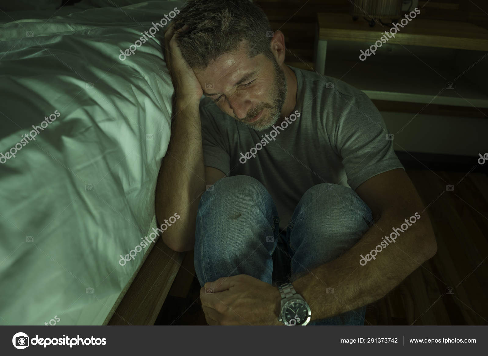 Dramatic home portrait of young desperate and depressed lonely man ...