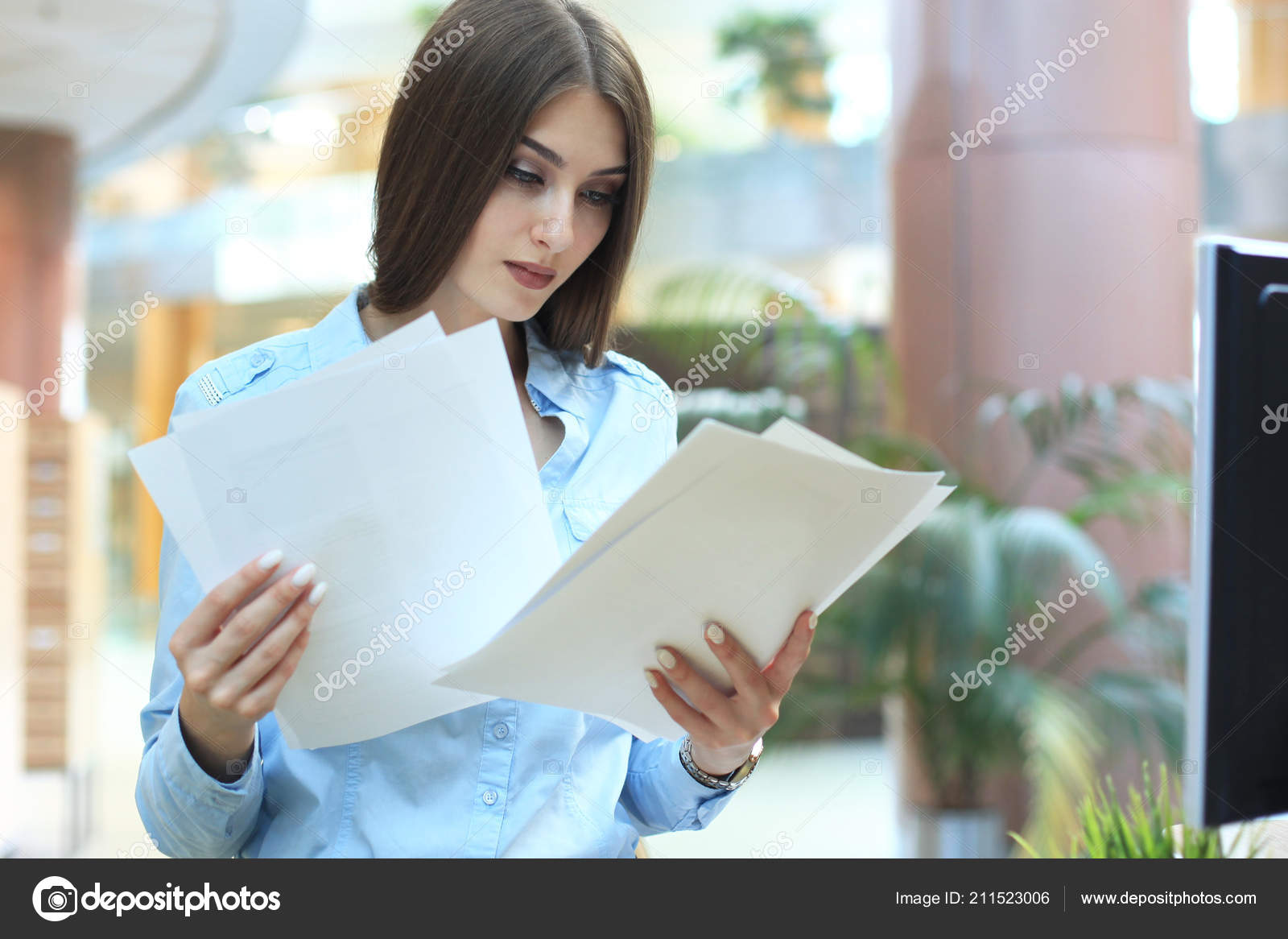 Concentrated business lady comparing documents at office. Stock Photo ...