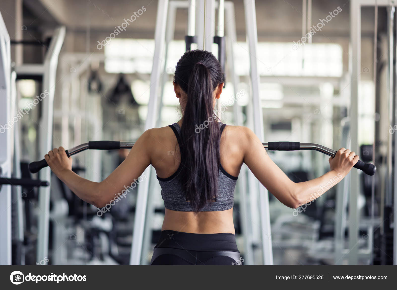 Woman exercise by pumping back in gym — Stock Photo © blanscape #277695526