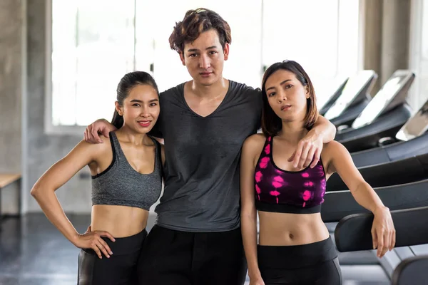 Portrait group of Asian sporty friends break and talk after running on ...