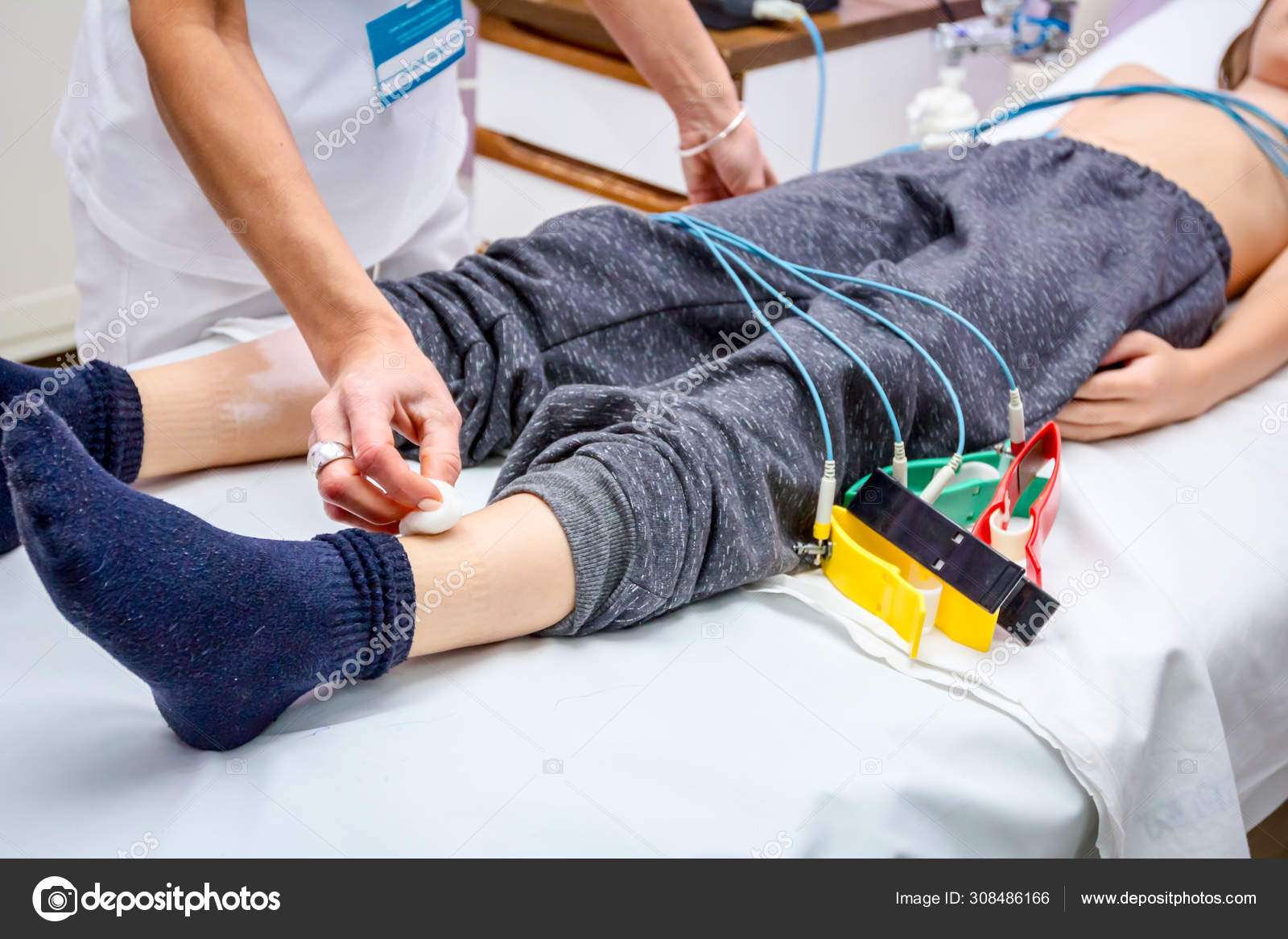 Nurse is preparing a child, teenager patient for ECG or EKG test ...