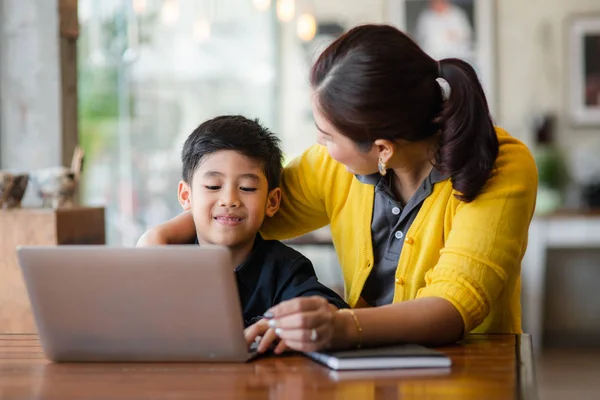 Happy Asian mother and her son raising their hands while win the Stock ...