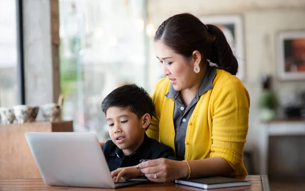 Happy Asian mother and her son raising their hands while win the Stock ...