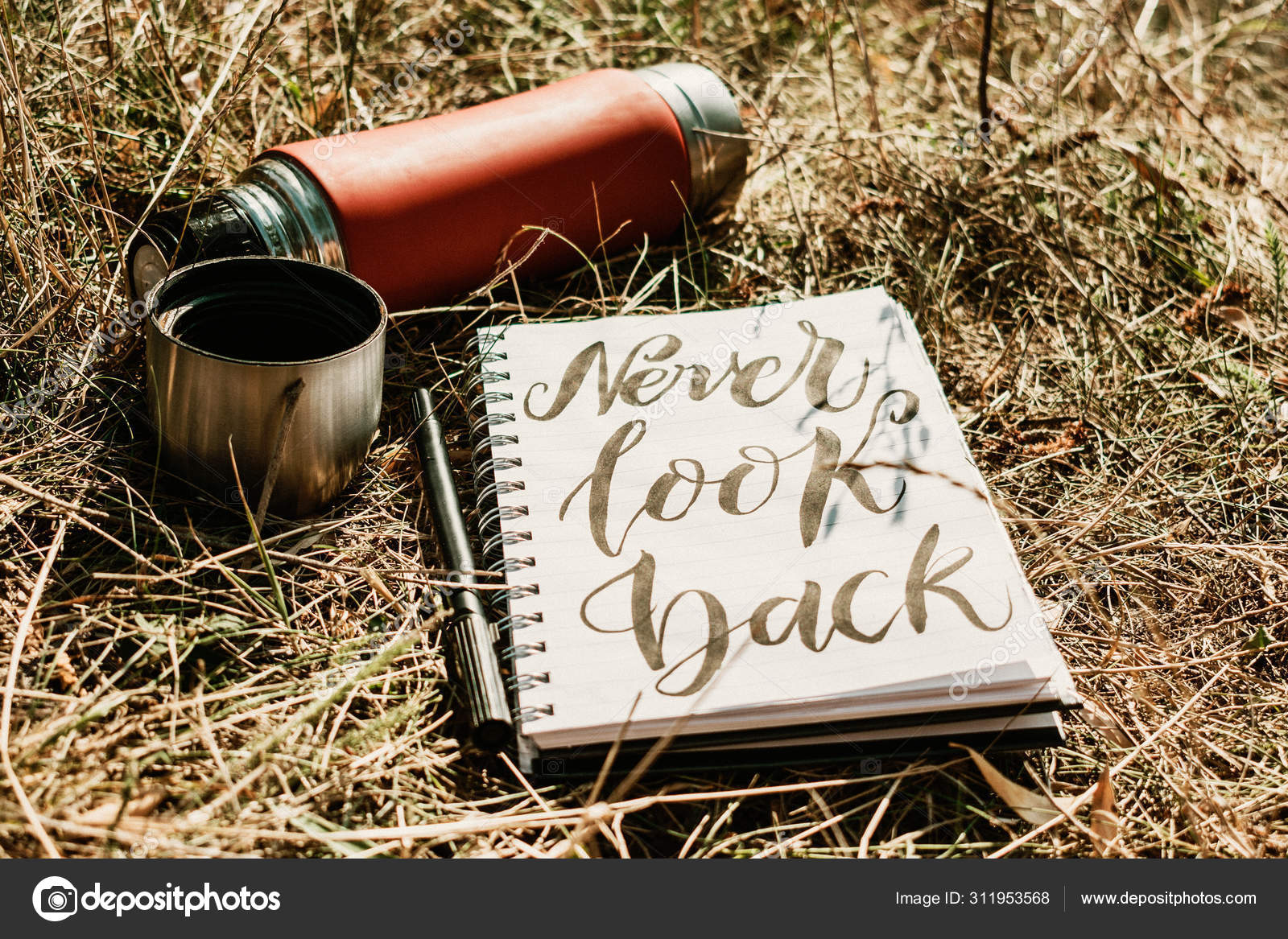 Never look back word written in white notebook with pen and red Stock ...