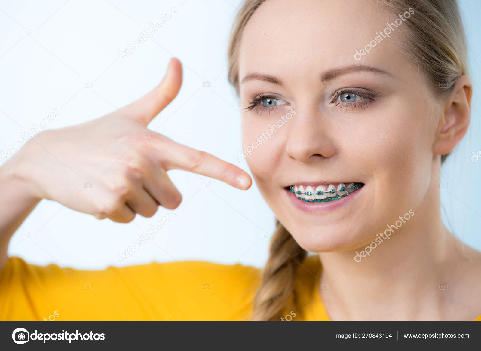 Woman showing her teeth with braces — Stock Photo © Voyagerix #270843194