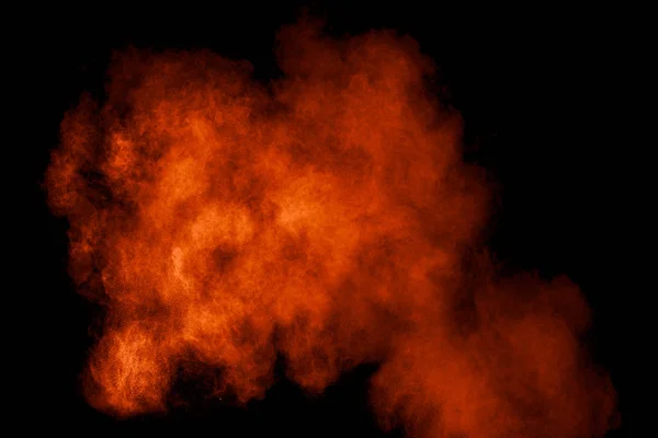 Orange red powder explosion on black background.Orange red color dust ...