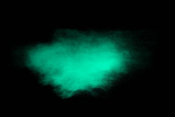 Green dust particles explosion on black background. Color powder dust ...