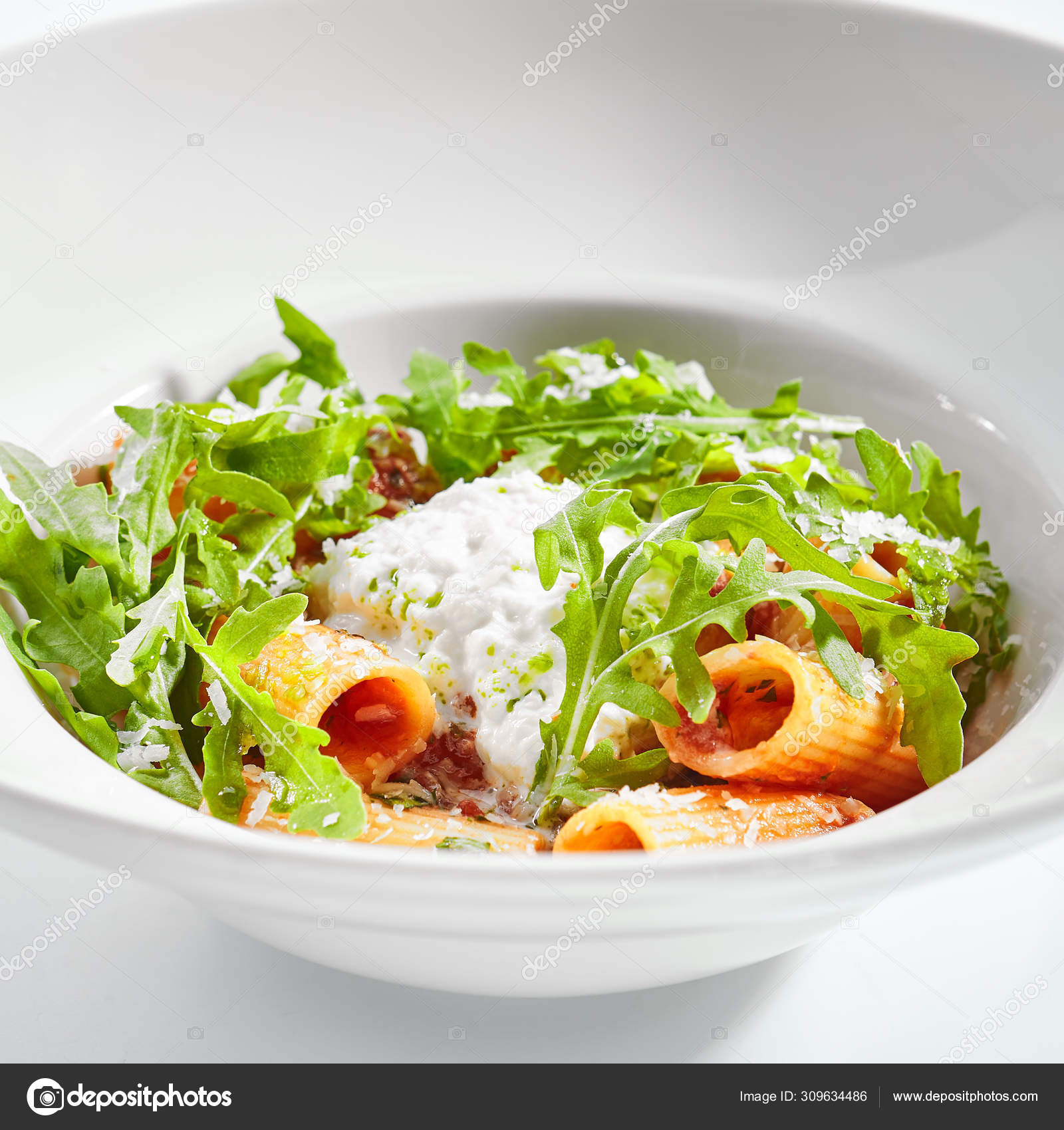Rigatoni in tomato sauce and stracciatella cheese Stock Photo by ...