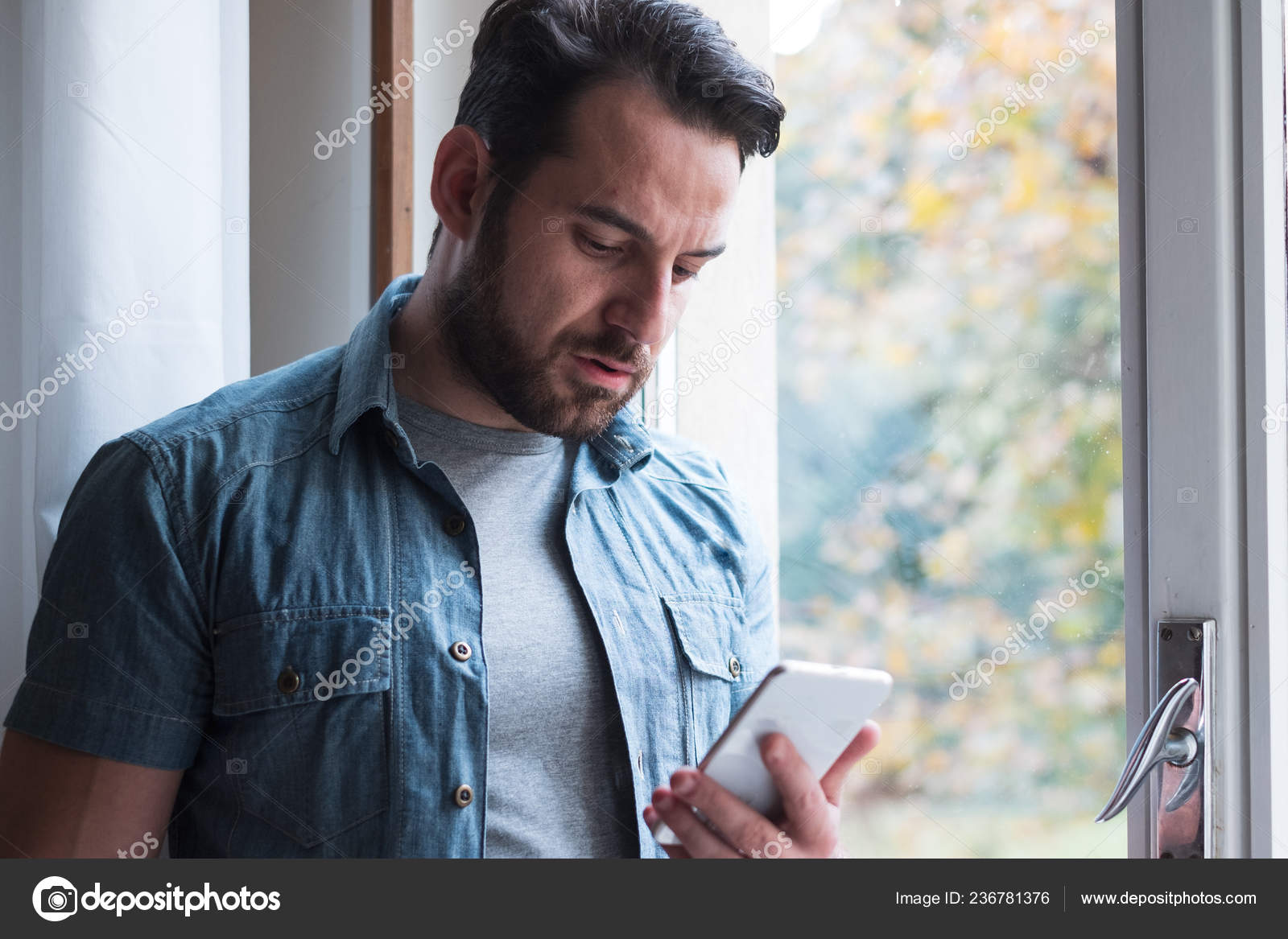 Sad Man Holding Phone Alone Home Stock Photo by ©tommaso1979 236781376