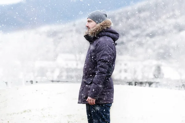 Man in cold and snowy weather storm in winter - Stock Image - Everypixel