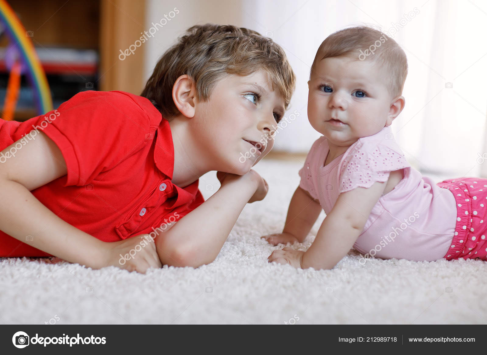 Happy little kid boy with newborn baby girl, cute sister. Siblings ...