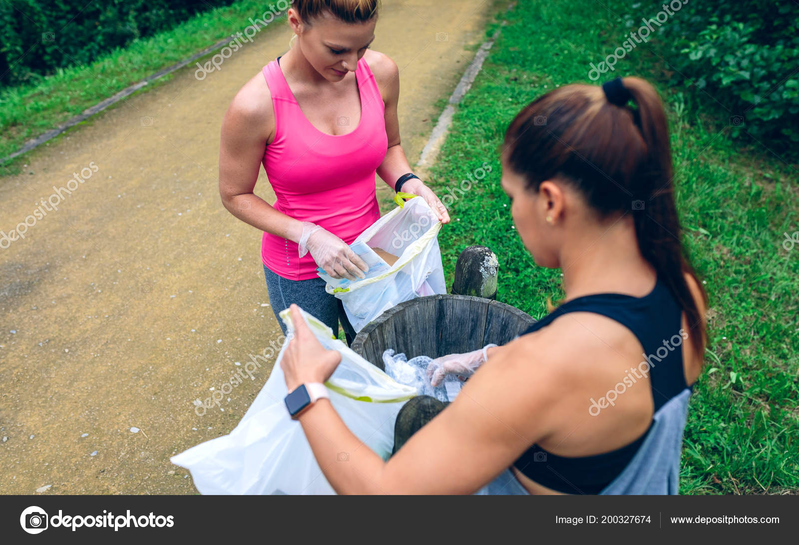 Two girls throwing garbage after plogging — Stock Photo © doble.dphoto ...