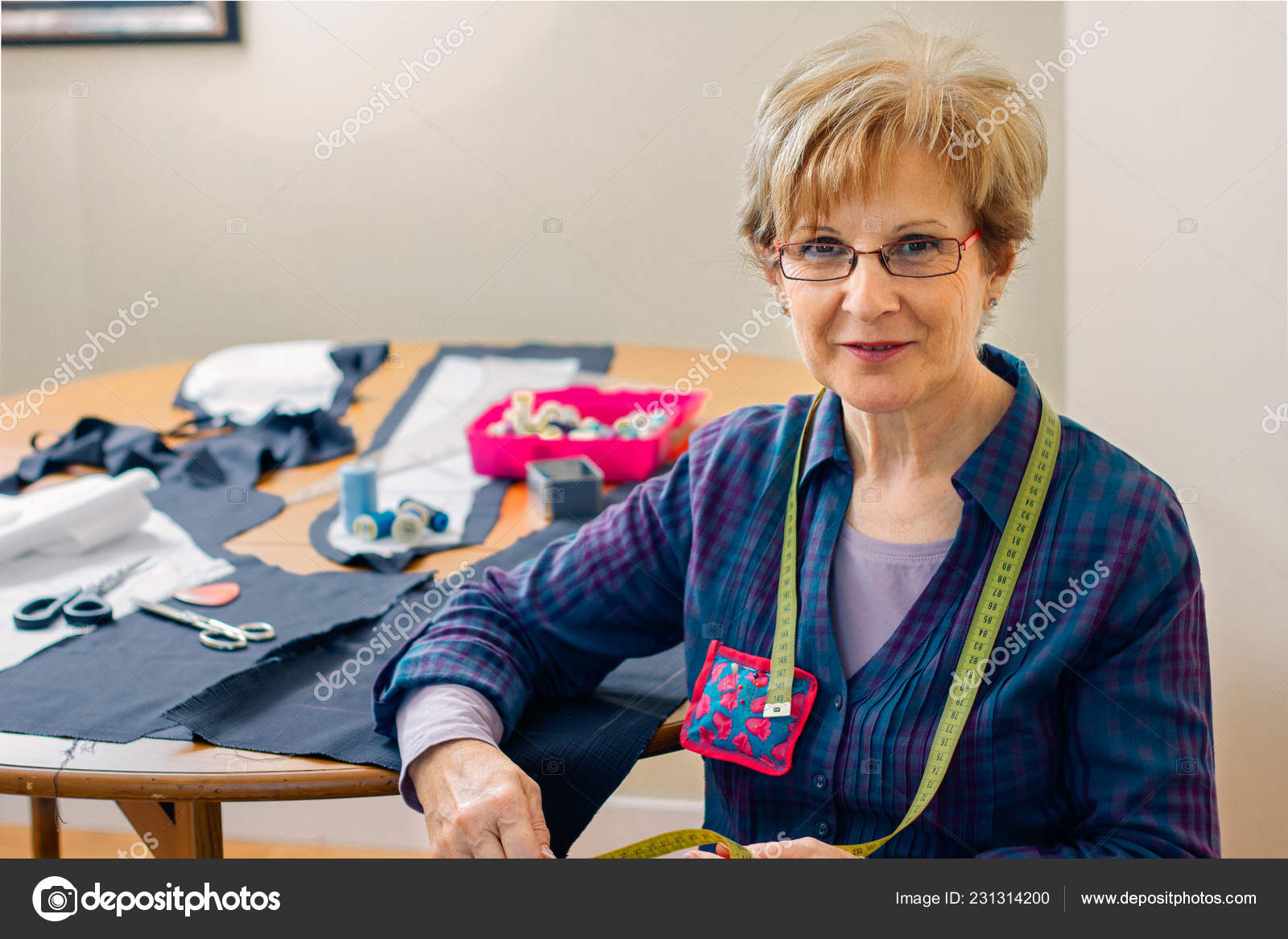 Senior dressmaker posing with sewing materials Stock Photo by ©doble ...