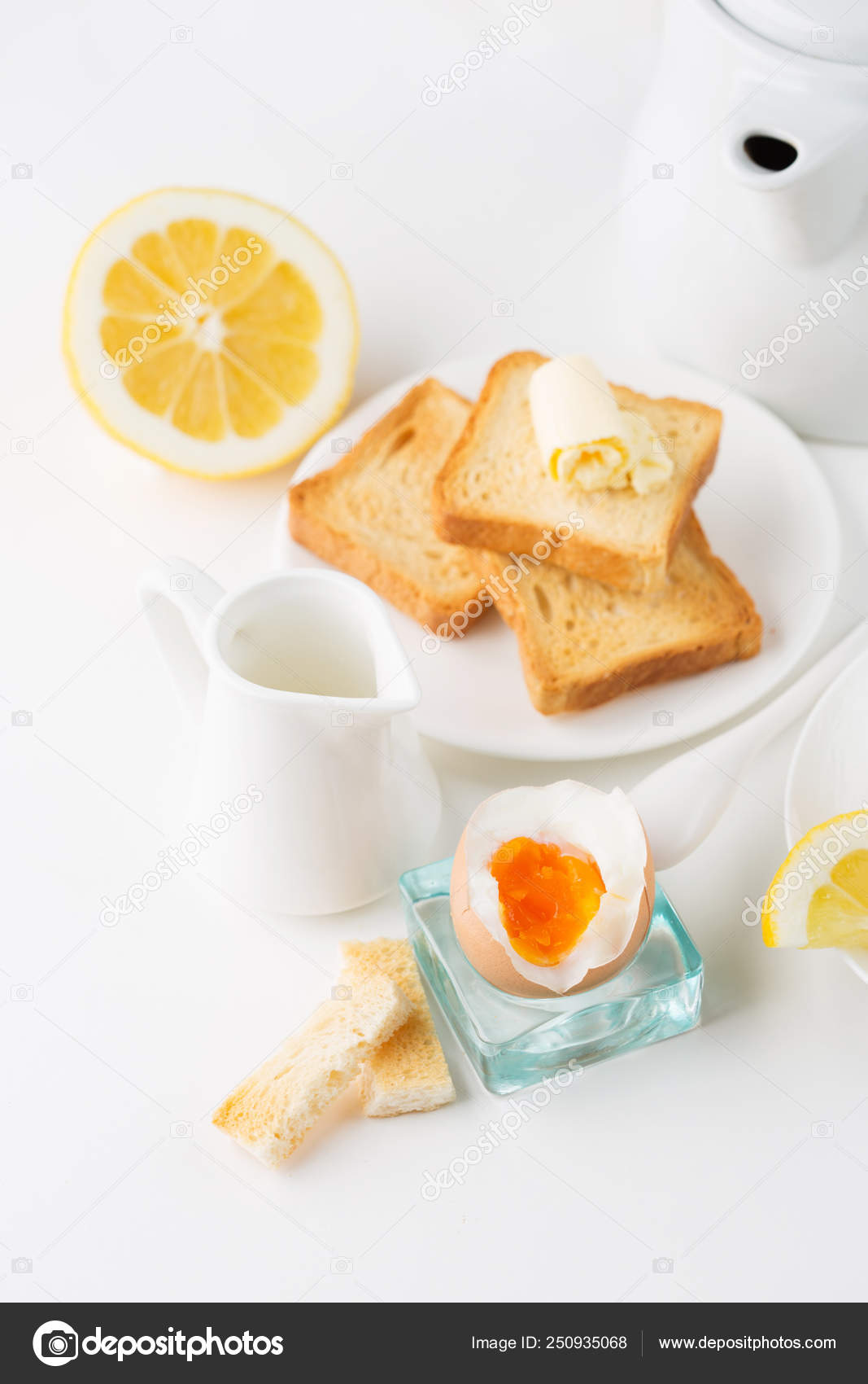 Breakfast with boiled egg, toasts, tea Stock Photo by ©Iuliia 250935068