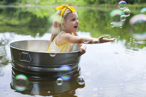 Little girl taking bath outside — Stock Photo © Legendaphotos #218896896