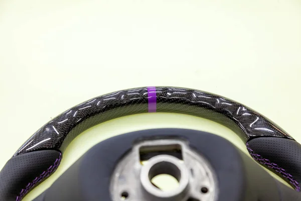 Close-up of the upper part of an exotic designer steering wheel made of ...