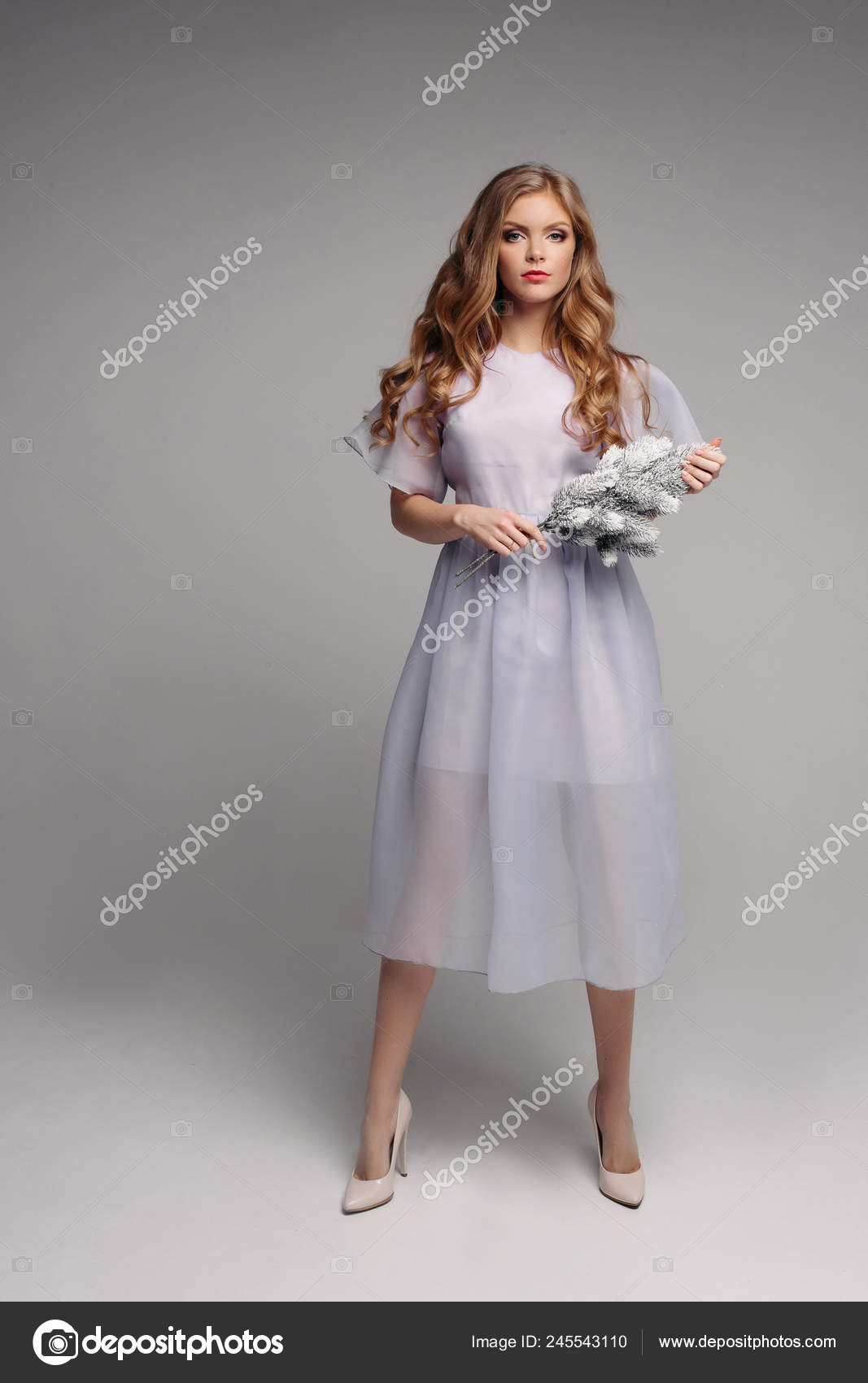 Front view of model in long dress looking at camera Stock Photo by ...