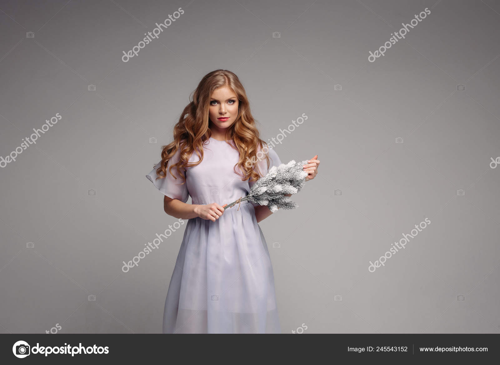 Front view of model in long dress looking at camera Stock Photo by ...