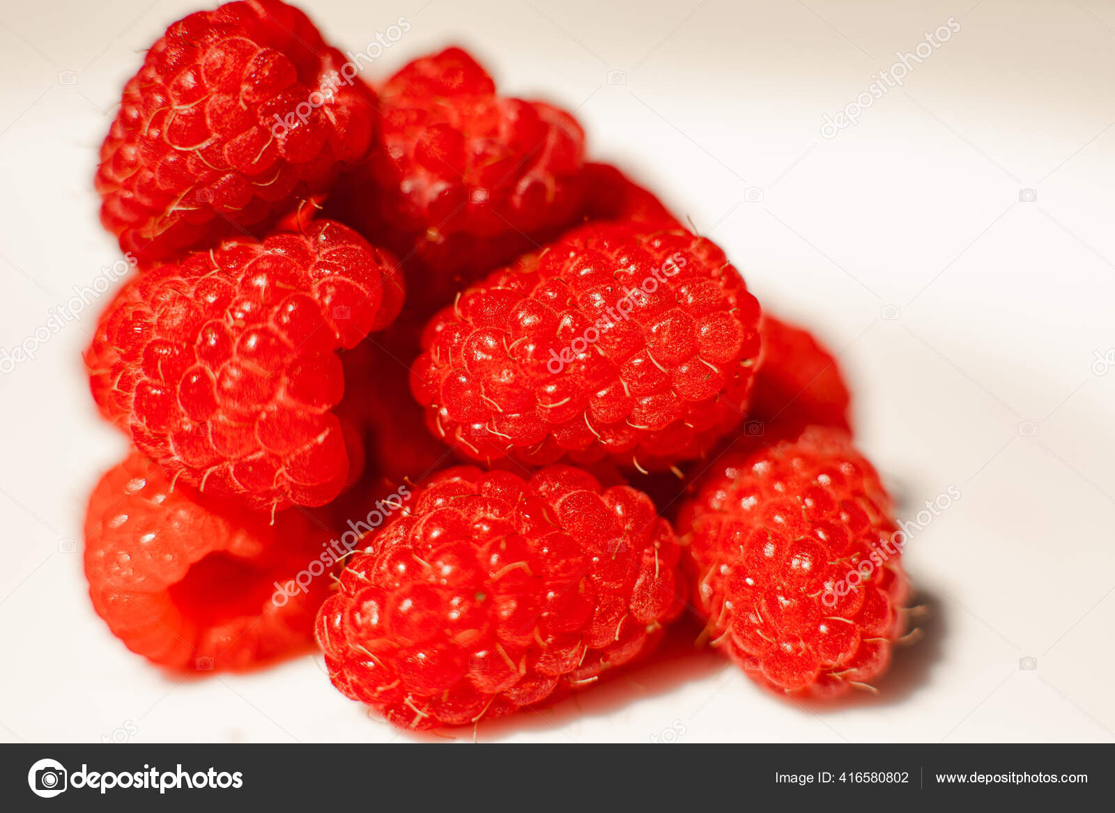 Beautiful raspberries in triangle shape lies isolated on a white ...