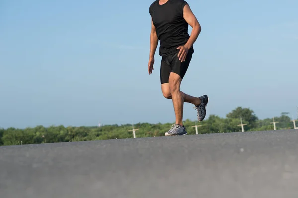 Down view of a man asia legs running in the time during sunrise on dam ...