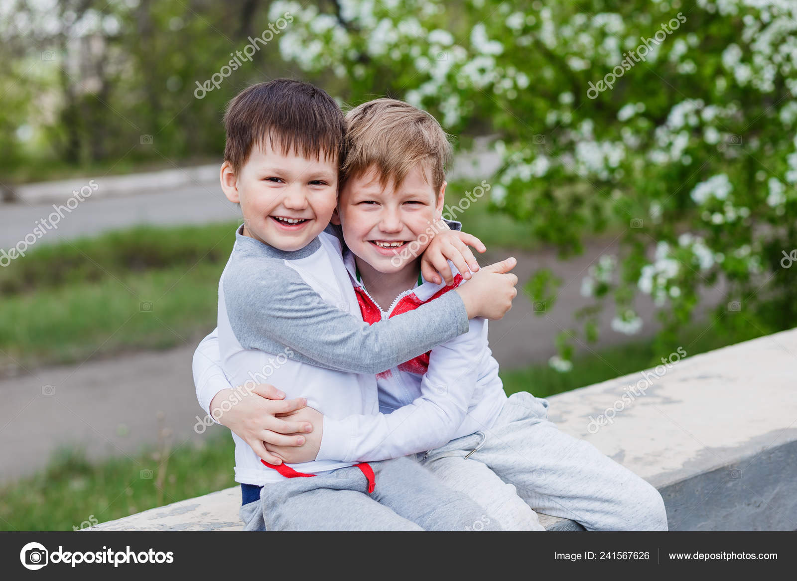 Two Happy Smiling Children Hugging Summer Outdoors Stock Photo by ...