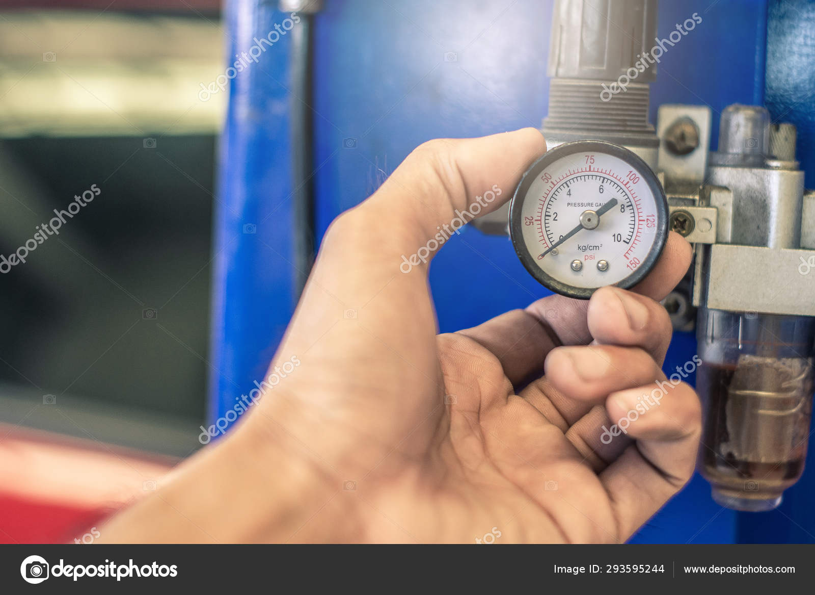 Man holding manometer with valve in car industry and car service Stock ...
