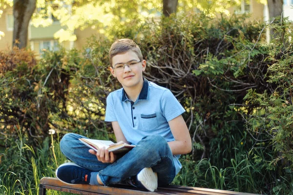 Social distance. Distance learning. Reading a book on the park. Look ...