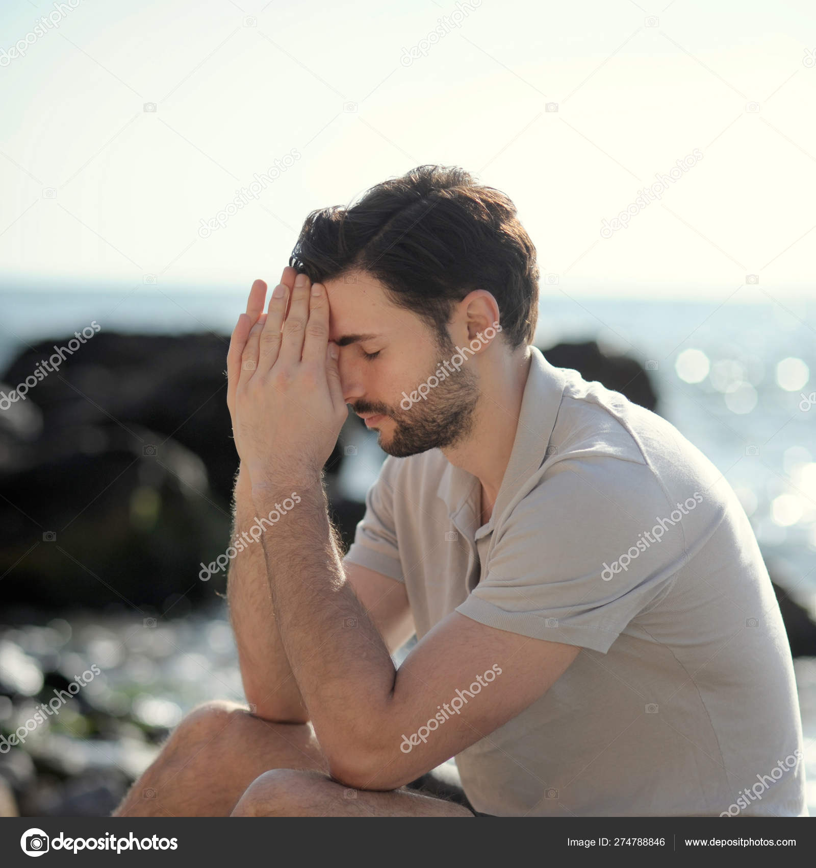 Praying man sitting on a sea beach Stock Photo by ©slena 274788846