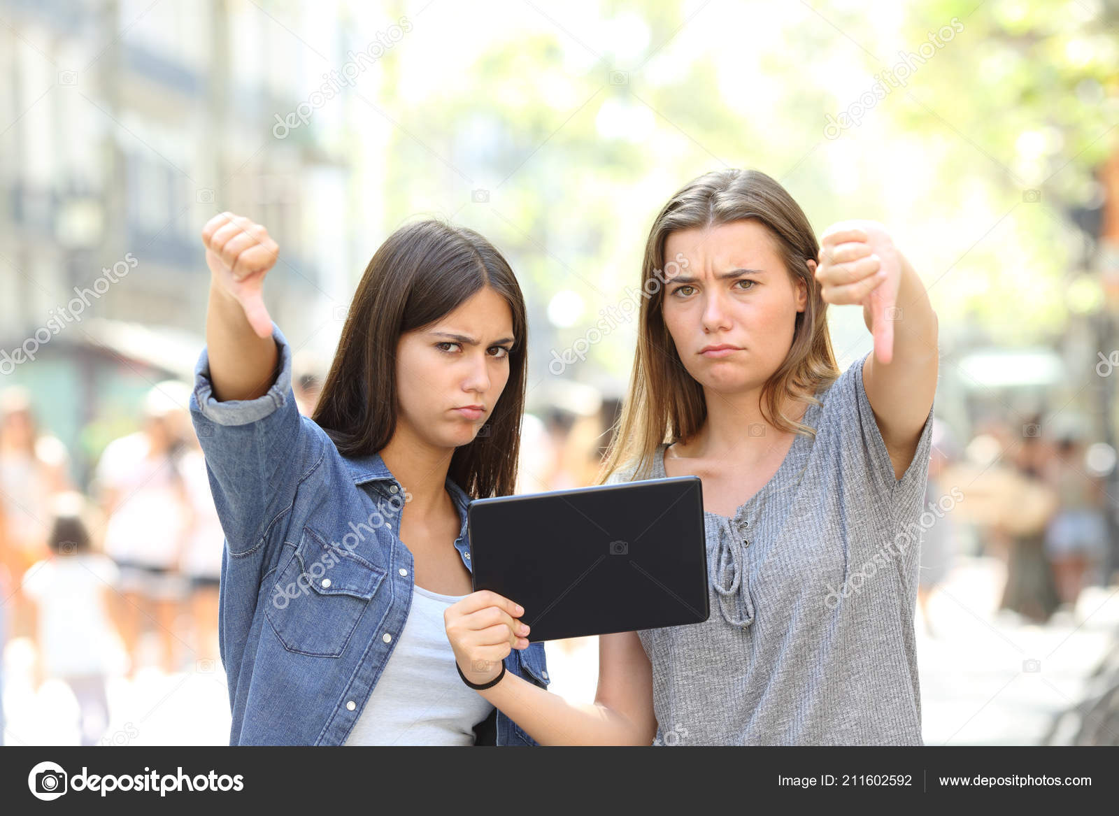 Two Angry Friends Holding Tablet Gesturing Thumbs Street — Stock Photo ...