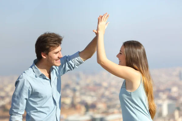 Happy friends giving high five outdoors in a city outskirts - Stock ...