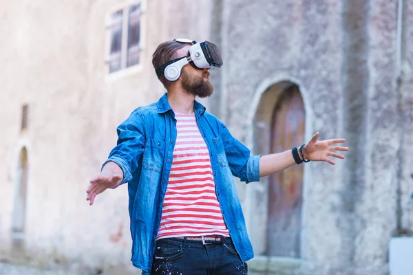 Man walking in the street in augmented or virtual reality headset. VR ...