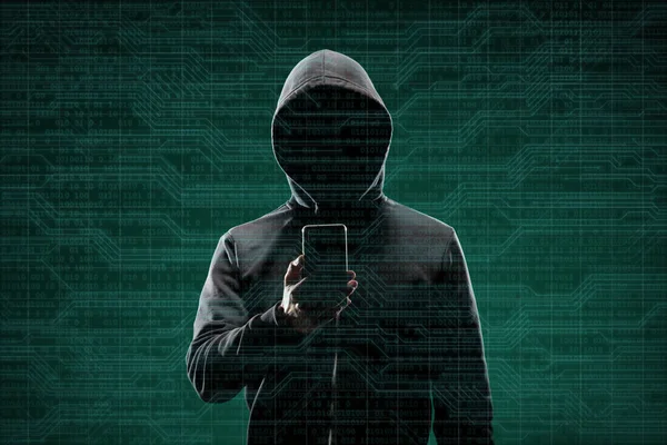 Computer hacker in mask and hoodie over abstract binary background. Obscured dark face. Data ...