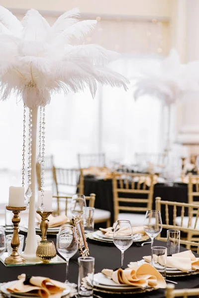 Stylish chairs and elegant gold-plated details. Black tablecloths on ...