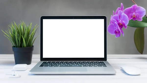 Laptop computer white blank screen on work table front view. Copy space ...