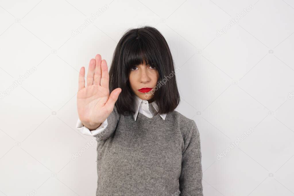 Young woman doing stop gesture with palm of the hand. Warning ...